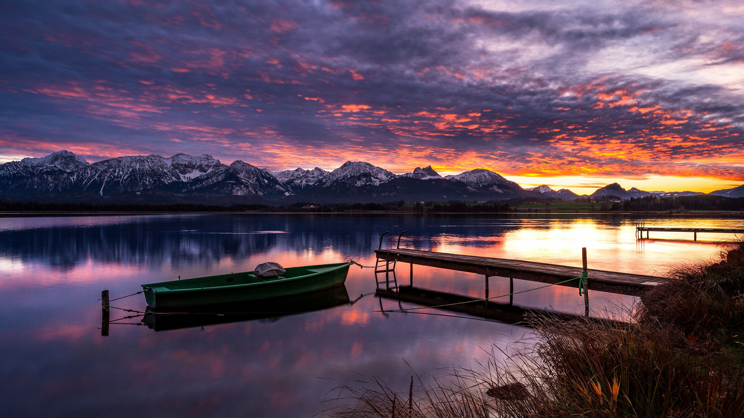 Hopfensee Lake Sunset With Mountains And Boats Wallpaper | PixieWall